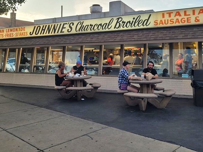 Dusk at Johnnie's—when the evening crowd gathers at the picnic tables, creating memories one bite at a time.