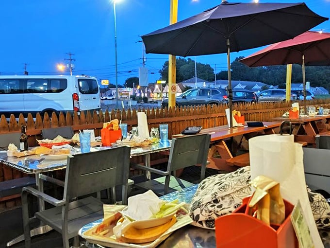 As twilight falls, the outdoor seating area transforms into a magical space where barbecue dreams and summer nights become one.