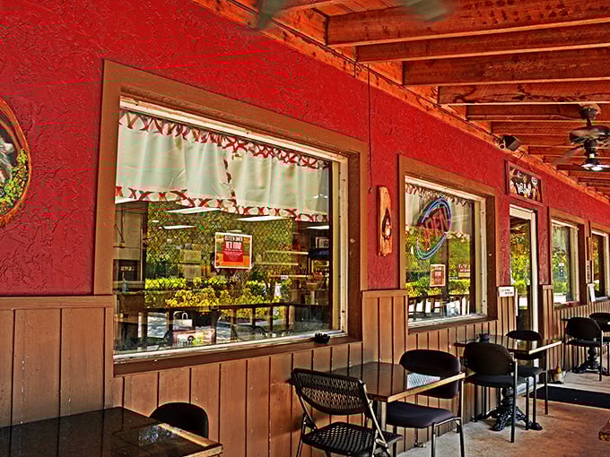 The outdoor seating area offers a glimpse into the diner's soul through red-framed windows that promise comfort food paradise within.