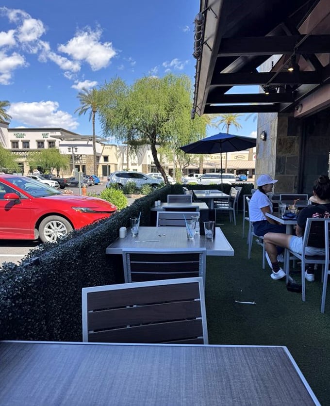 Outdoor seating under Arizona's famous blue skies. Palm trees and patio tables create the perfect setting for that "I'm-definitely-posting-this" brunch moment.