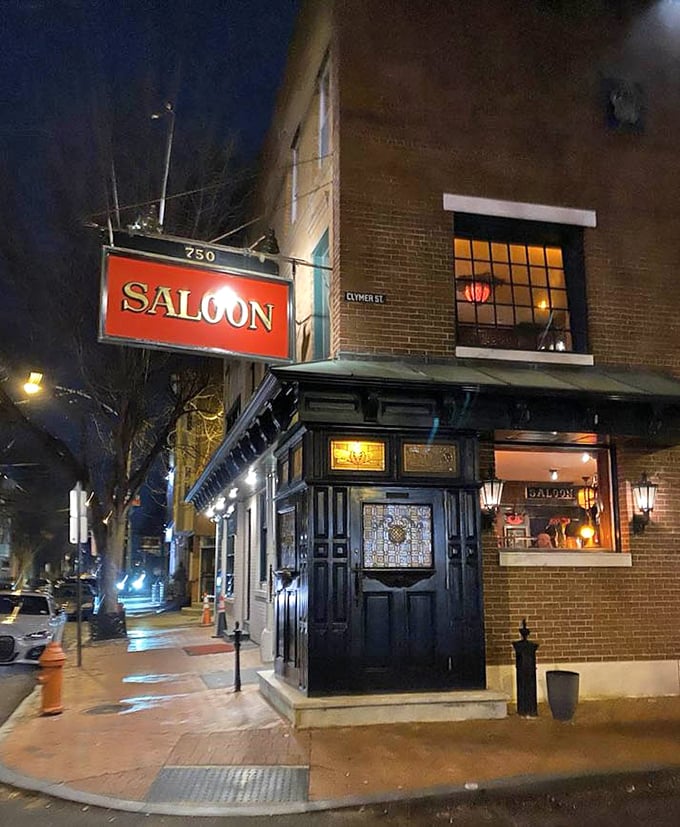 By night, The Saloon's exterior glows with promise, a beacon for those seeking refuge from mediocre meals.