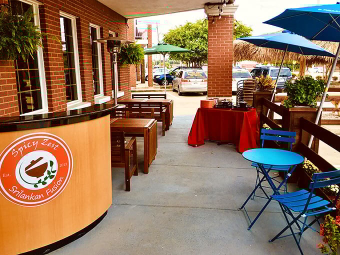 Outdoor seating with pops of blue and red offers Texas sunshine with your Sri Lankan spice—nature's perfect dining companion.