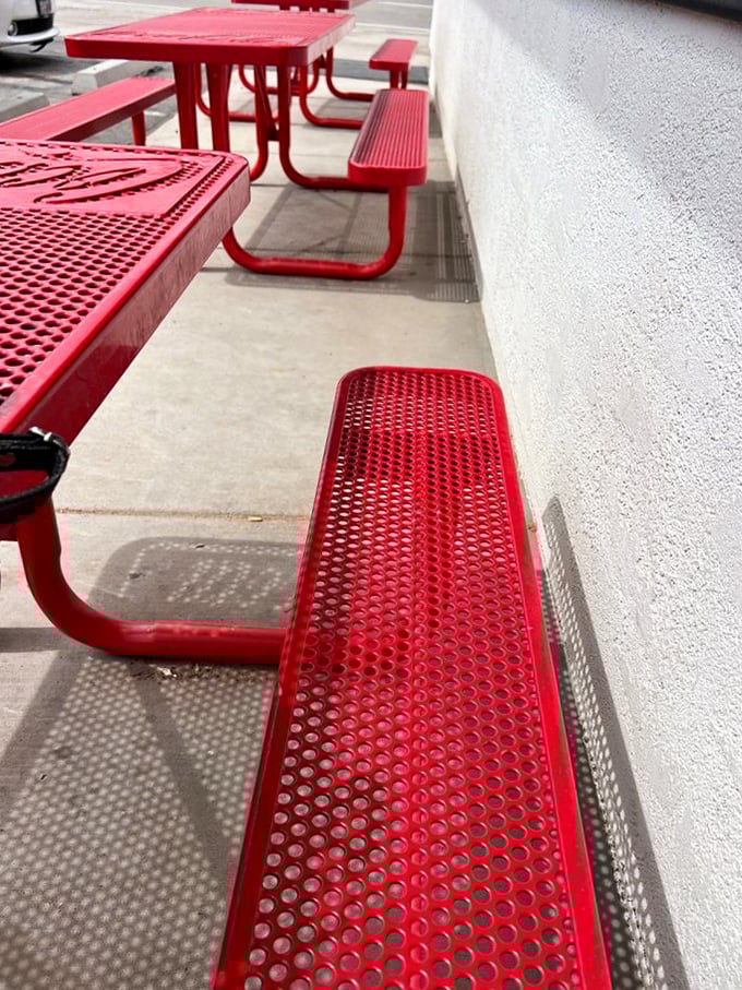 Those red picnic tables outside aren't just seating—they're front-row tickets to people-watching with the added bonus of desert breezes between bites.