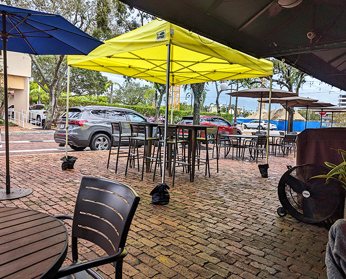 Brick pavers and outdoor tables create an urban oasis where breakfast conversations flow as freely as the coffee refills.
