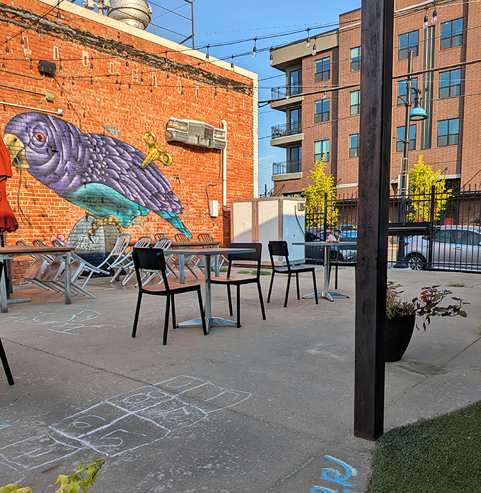 Outdoor seating with urban art backdrop—because sometimes your breakfast needs a side of street culture and fresh air.
