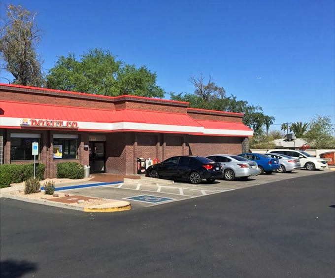 The parking lot view – where cars gather like pilgrims at a shrine dedicated to the religion of really good breakfast.
