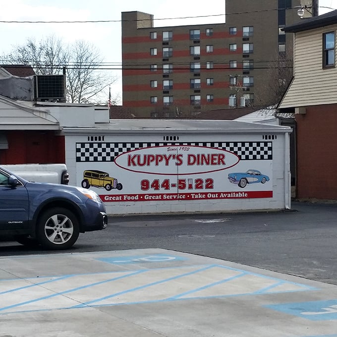 The side view reveals Kuppy's promise of "Great Food • Great Service" and the vintage car illustrations remind us this place has serious history.