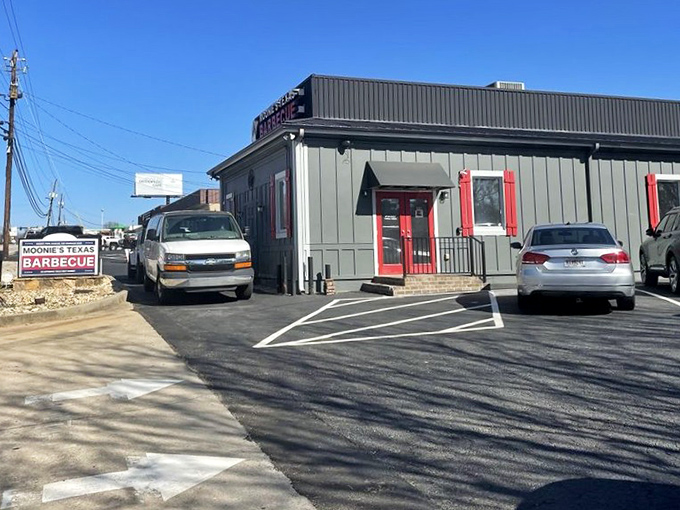 The parking lot – where vehicles gather like pilgrims at a shrine, their drivers united by the universal language of barbecue.