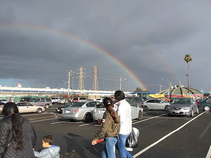 Even the weather celebrates bargain hunting with a perfect rainbow arching over the parking lot—nature's own "Open for Business" sign.