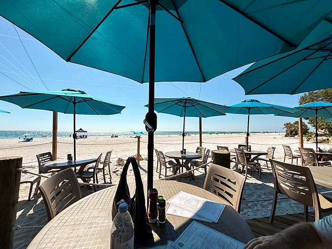 Dining with your toes in the sand isn't a metaphor here—it's Tuesday. Those turquoise umbrellas frame Gulf views like living postcards.