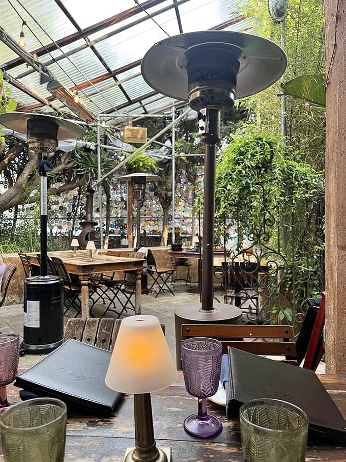 Patio heaters and mismatched glassware signal a place where comfort matters more than matching everything perfectly—as it should.