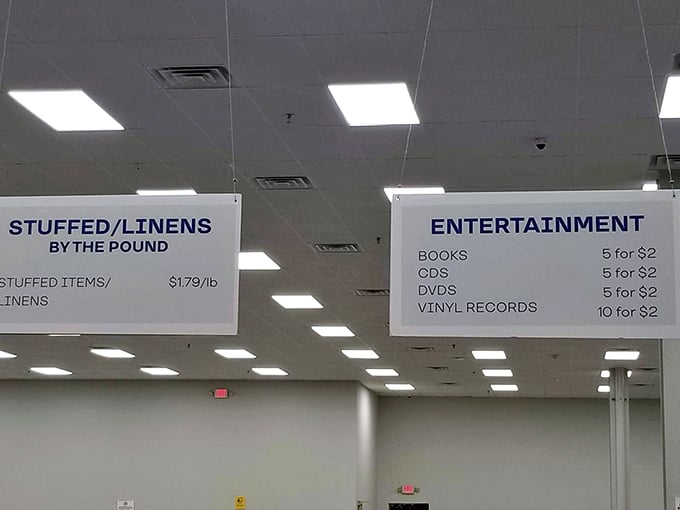 The pricing board reveals the outlet's secret weapon: entertainment at five for $2 and linens by the pound. These aren't typos—they're treasures!