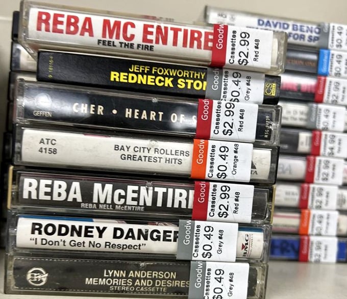 Country music history preserved in plastic cases. Reba and Rodney Dangerfield sharing shelf space is the crossover event we didn't know we needed.