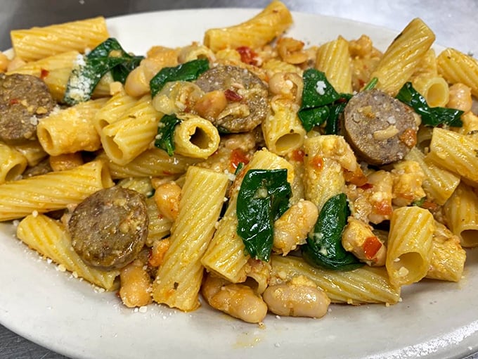 This rigatoni doesn't just have sausage; it has a meaningful relationship with it—pasta tubes catching sauce in their hollow centers like flavor catchers.
