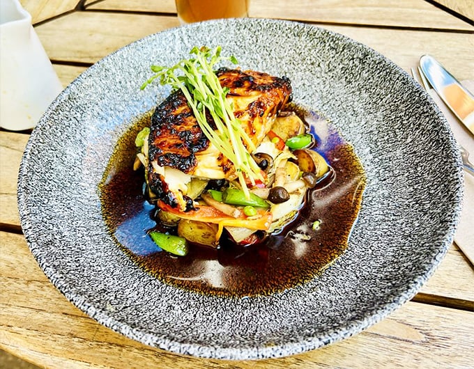 The sake-glazed sea bass isn't just dinner—it's edible art, with vegetables playing supporting roles in a delicious drama of textures and flavors.