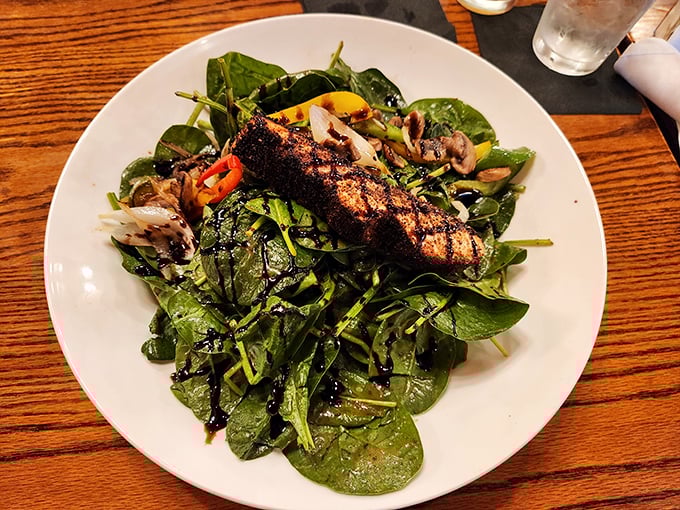 A spinach salad topped with grilled salmon that proves Hamley's isn't just about red meat – it's about doing everything with steakhouse swagger.