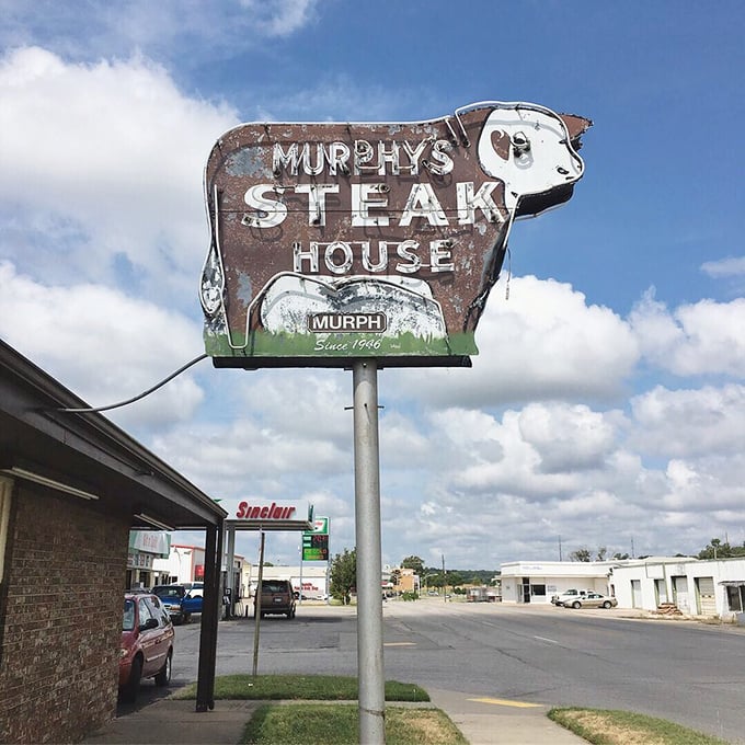 That weathered cow sign doesn't just advertise a restaurant—it announces an institution where Oklahoma's comfort food traditions are preserved one chicken fried steak at a time.