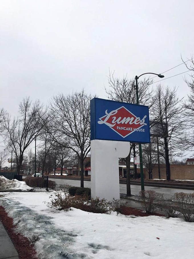 Even in winter's grip, the Lumes sign stands defiant – a blue and red beacon promising warm pancakes in a cold world.