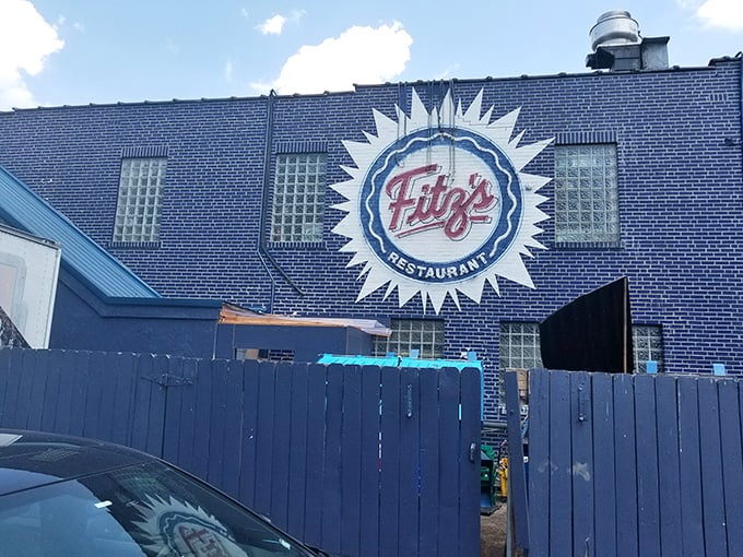 The sunburst logo announces your arrival at flavor headquarters, where burgers and bottling operations coexist in delicious harmony.