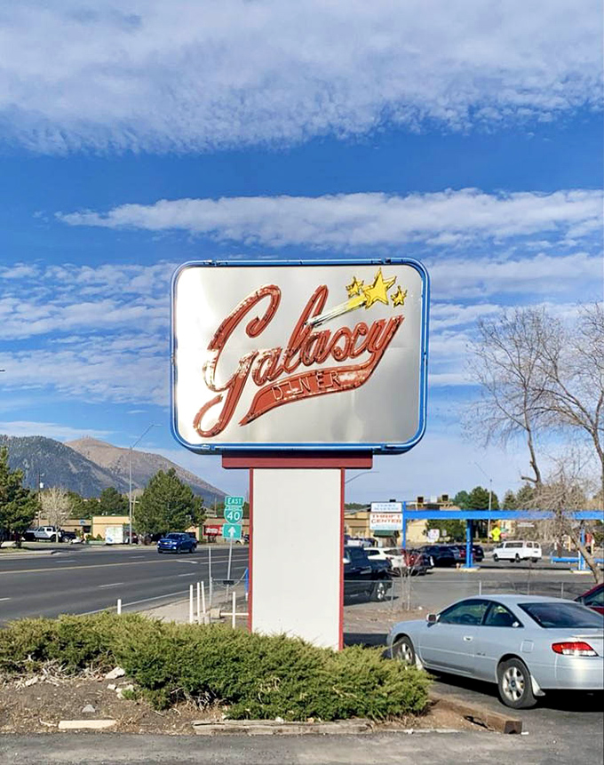 The roadside sign stands tall against Flagstaff's mountain backdrop – a shining reminder that good diners, like good friends, are always worth the drive.