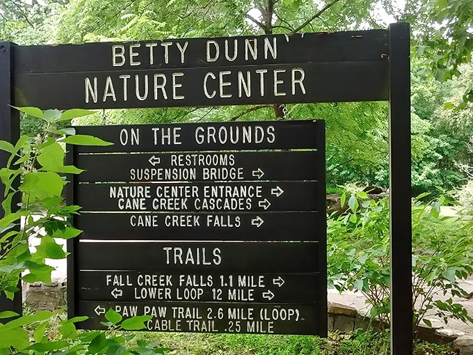 The Betty Dunn Nature Center sign doesn't just provide directions – it offers a choose-your-own-adventure menu for wilderness explorers of all ambition levels.