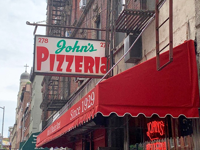 That vintage sign has guided hungry New Yorkers through depression, war, and disco – a beacon of pizza consistency in a changing city.