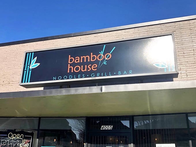 The sleek signage announces "Noodles • Grill • Bar" with understated confidence—three simple words that promise a world of flavor behind those doors.