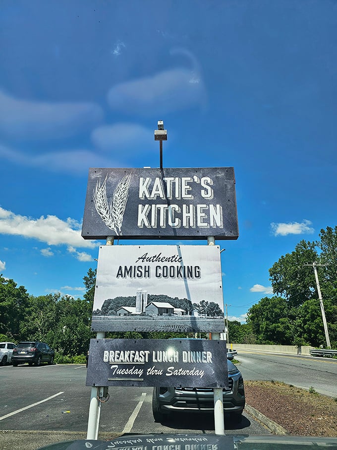 Against a brilliant blue sky, Katie's Kitchen sign stands tall – a landmark for those in the know seeking authentic Amish cooking.