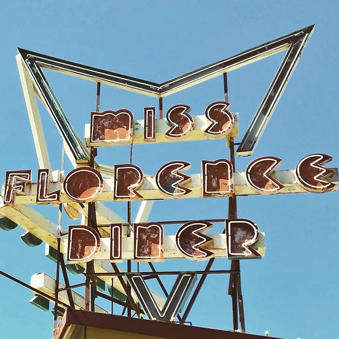 That retro sign against a blue sky promises more than just food – it's a portal to an era when diners were America's great democratic dining rooms.