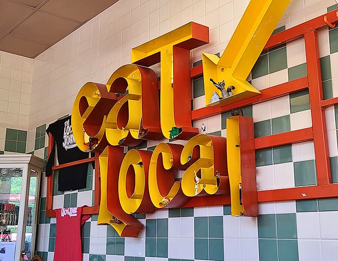 The cheerful bright yellow lettering surrounded by checkered walls radiates warmth and pride—a vibrant invitation to savor the flavors of home.