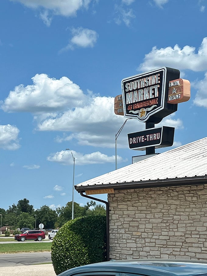 The iconic sign against a Texas blue sky – a beacon of hope for barbecue lovers and a landmark that's guided hungry travelers for generations.