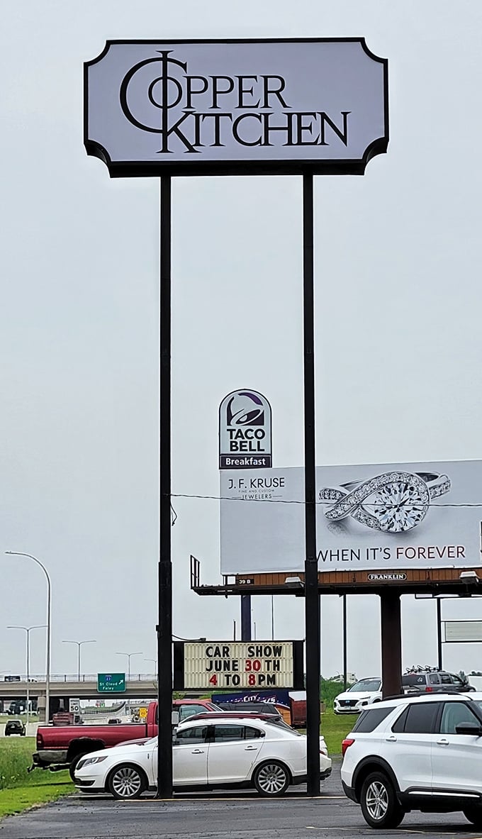 The sign stands tall against the Minnesota sky, a North Star for hungry travelers who know that good food doesn't need fancy advertising.