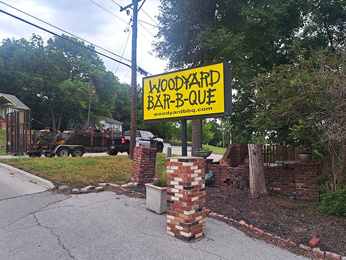 That yellow sign isn't just a logo—it's a promise of smoky treasures that await. The brick pillars stand guard over Kansas City's barbecue legacy.