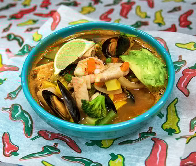 This seafood soup doesn't just warm you—it tells stories of coastal kitchens with every spoonful. The avocado and lime are perfect supporting actors.