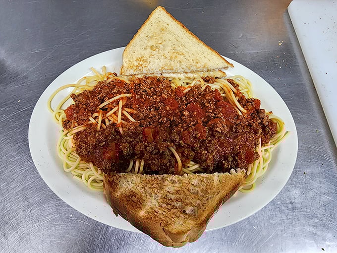 Spaghetti with meat sauce that doesn't pretend to be Italian—it's pure Wisconsin comfort, sandwiched between perfectly buttered toast.