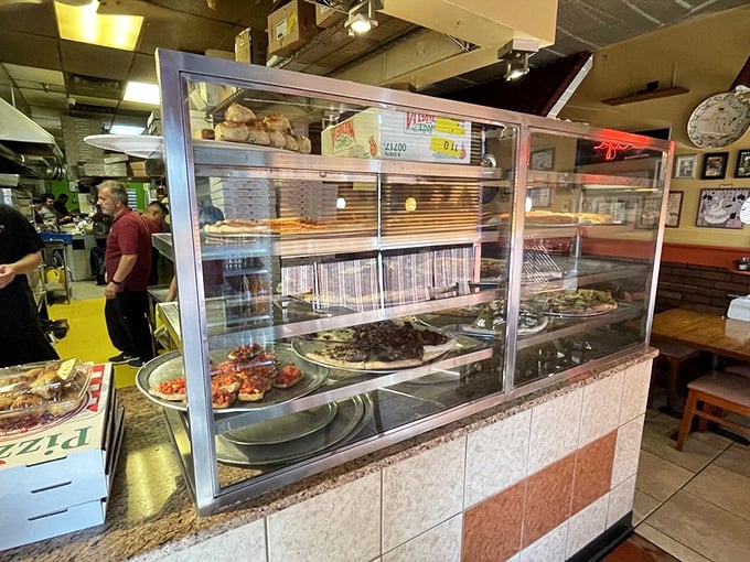 Where the magic happens—Tony's kitchen crew crafts Italian classics while customers eagerly await their turn at the display case of dreams.