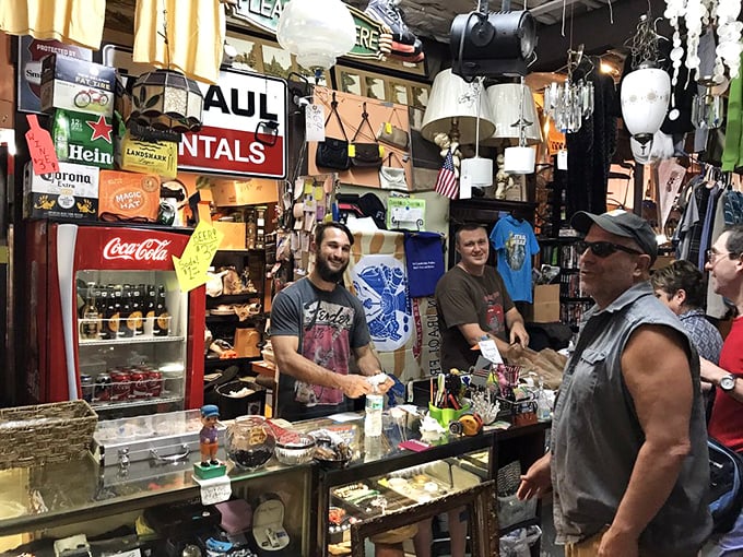 The checkout counter doubles as an impromptu community gathering spot. These folks aren't just selling vintage—they're curating memories and making connections.