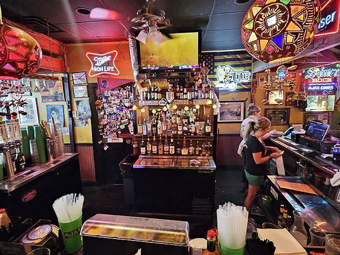 Behind the bar, where the magic happens. Those neon signs aren't just decoration – they're beacons guiding hungry souls to salvation.