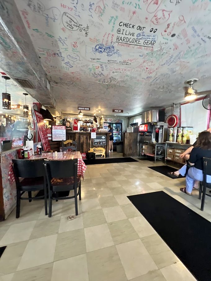 Where the magic happens—an interior that says "focus on the food, not the frills." The ceiling of customer signatures tells the real story of this place.