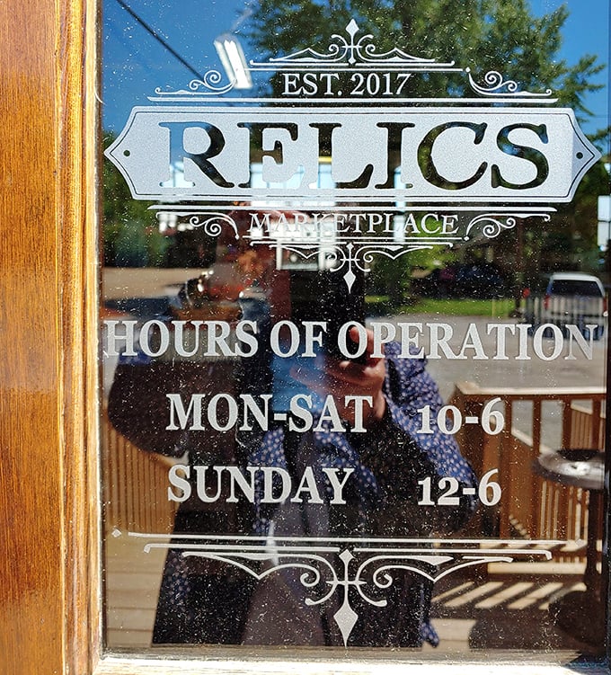 Business hours carved in glass—the elegant signage itself a relic of when store information was an art form, not just a Google search.