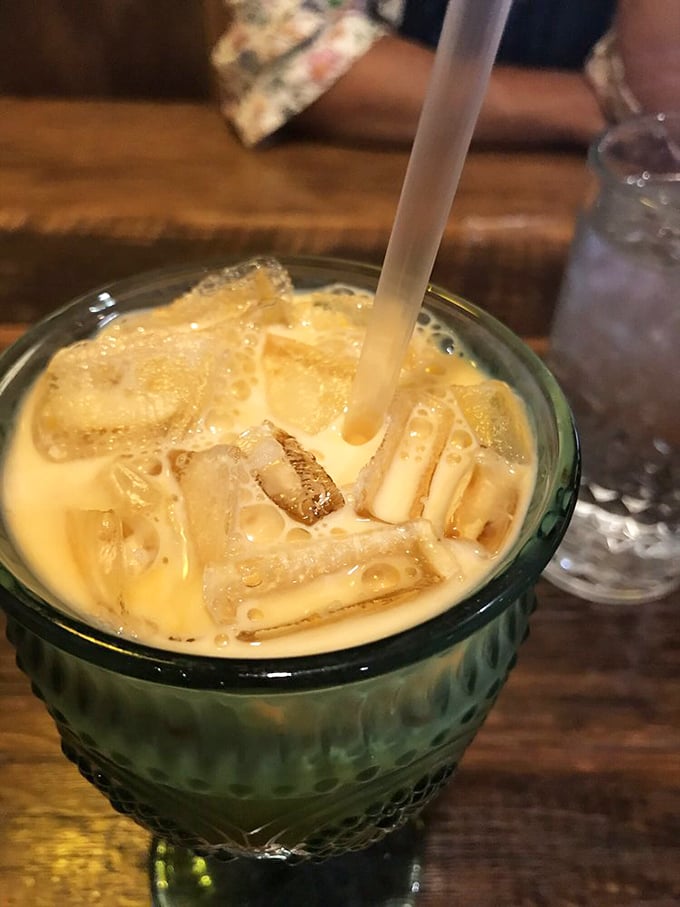 Thai iced tea: that magical elixir where sweetened condensed milk meets strong tea in a glass. It's basically dessert with caffeine—the perfect combination.