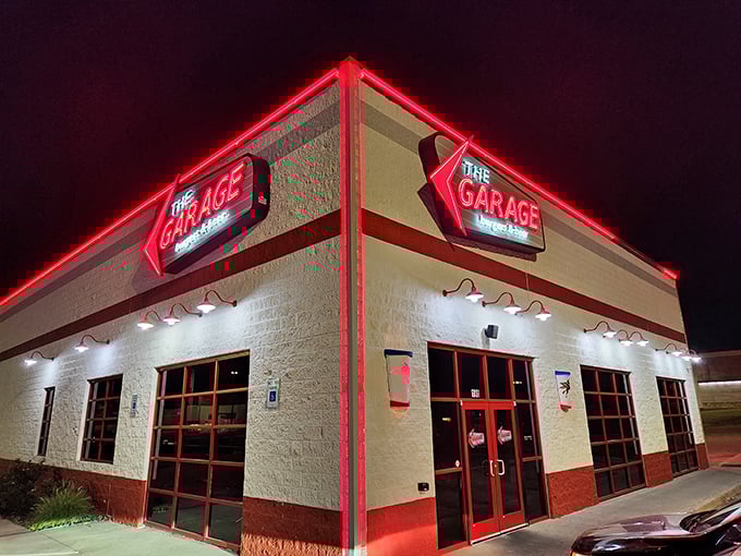 The Garage glows with neon promise after dark. Burgers taste better when served with a side of unpretentious atmosphere.