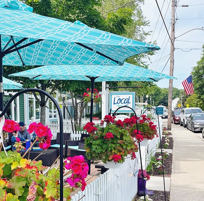 "Local" isn't just a name—it's a philosophy. Vibrant flowers and turquoise umbrellas create an irresistible sidewalk oasis.