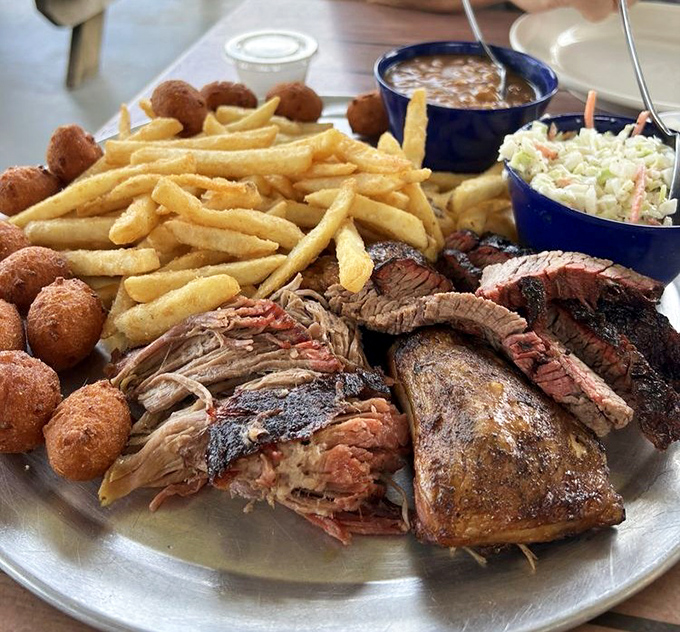 The Sampler Platter is barbecue's greatest hits album—pulled pork, brisket, chicken, golden hushpuppies, and sides that make choosing just one meat unnecessary.