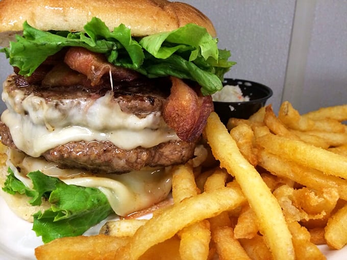 This isn't just a burger—it's a tower of power with melted cheese cascading down like a dairy waterfall. Napkins: mandatory.
