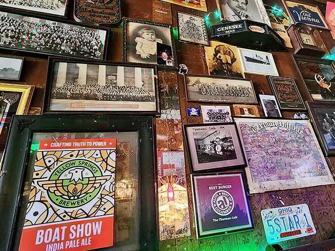 Every inch of wall space serves as a canvas for memories – license plates, sports pennants, and local brewery signs create a tapestry of Ohio pride.