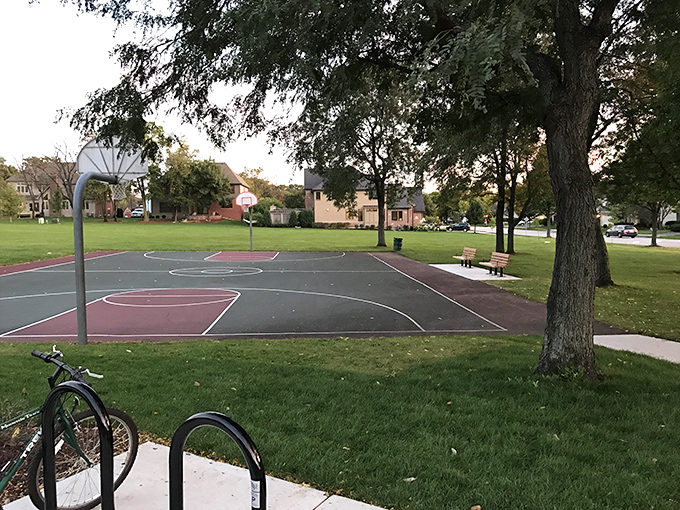 This neighborhood basketball court waits patiently for weekend warriors to relive their high school glory days, knee braces and all.
