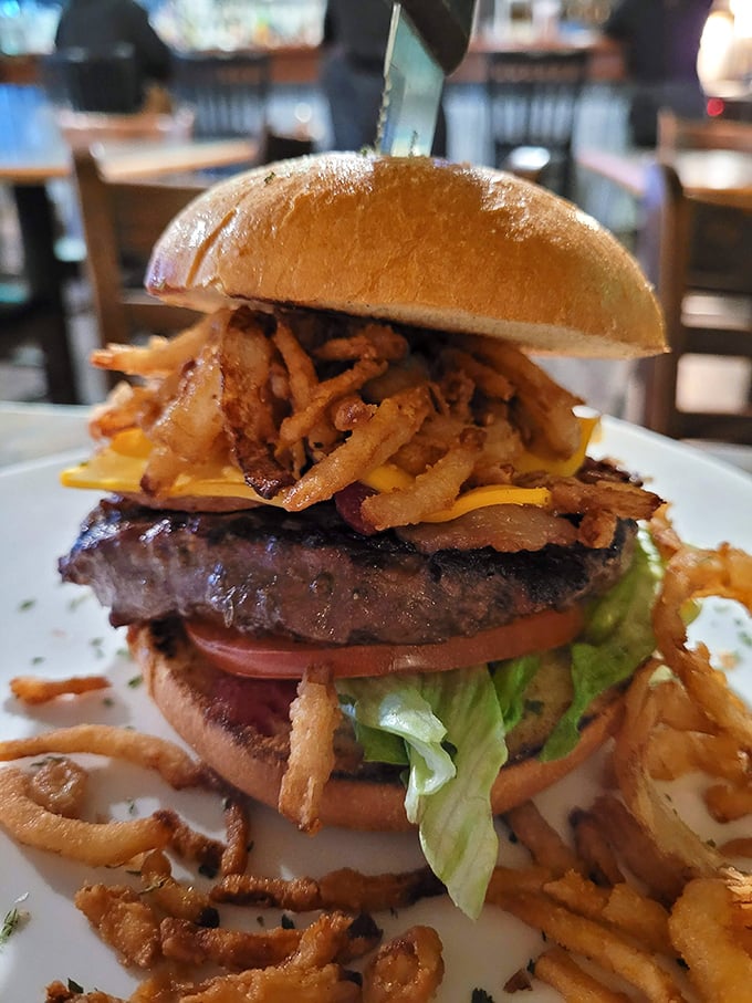 This isn't just a burger—it's a towering monument to excess with crispy onion straws that should have their own fan club.