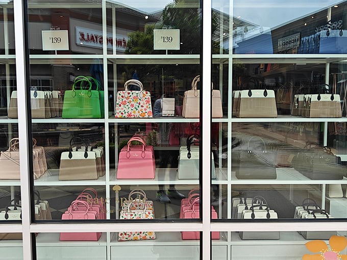 Kate Spade's handbag display window – where colorful leather dreams sit pretty at $139. Your credit card is already reaching for its wallet.