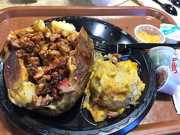 The loaded baked potato – a magnificent vessel for delivering more barbecue to your face. It's not just a side; it's a strategy.